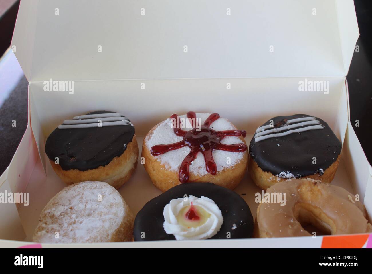 High-angle shot of an assortment of donuts in a paper box Stock Photo ...