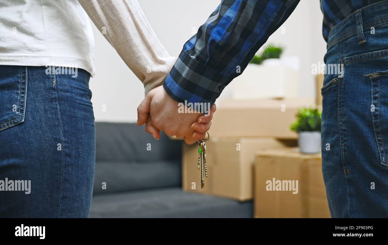 Family couple holding keys to new home on moving day Stock Photo - Alamy