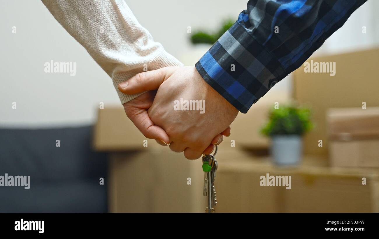 Family couple holding keys to new home on moving day Stock Photo - Alamy