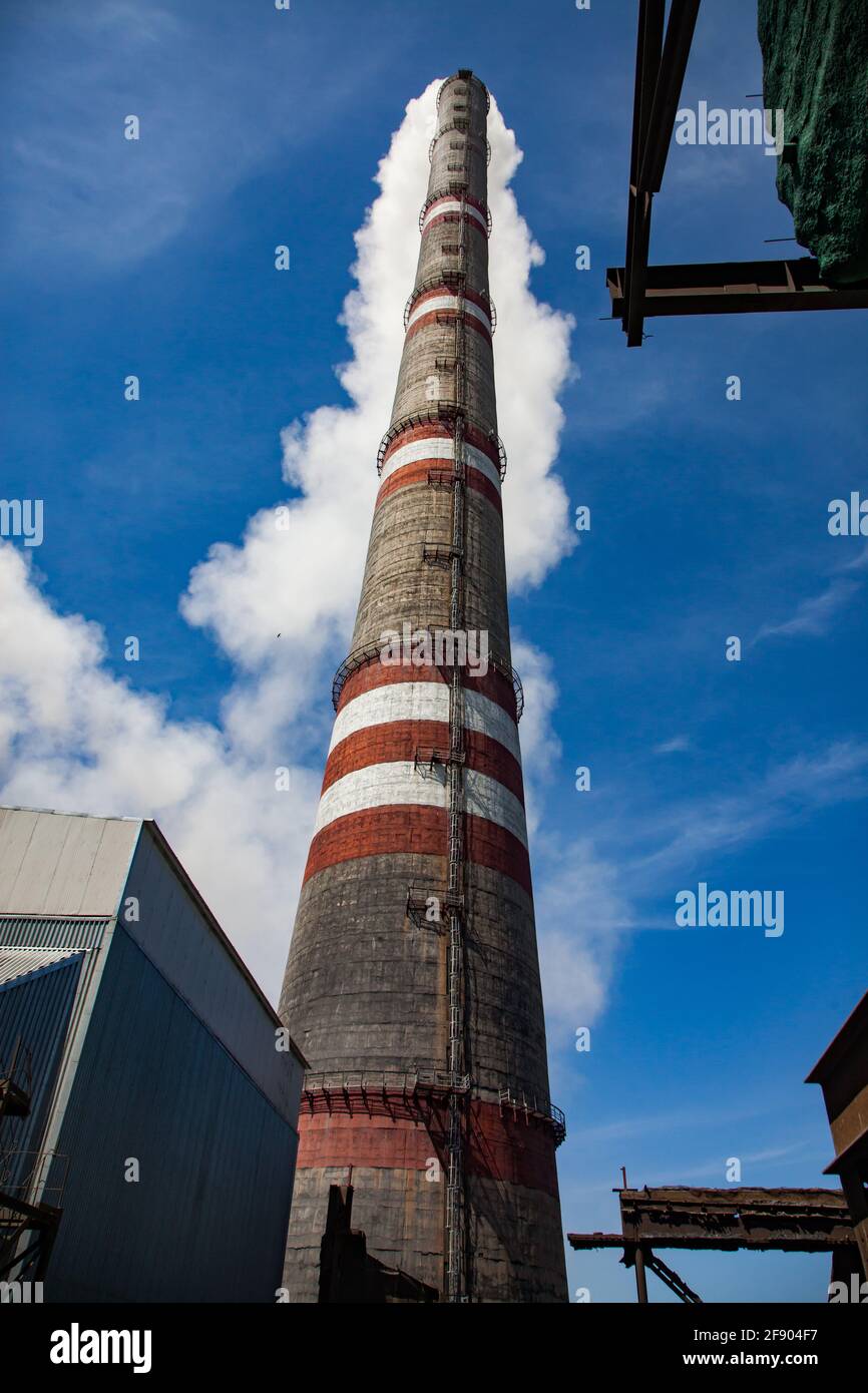 GRES-1 thermal power plant roof. Tall smoke stack with white smoke ...