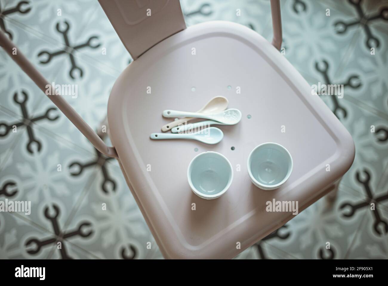 Overhead view of ceramic bowls and spoons on a chair Stock Photo - Alamy