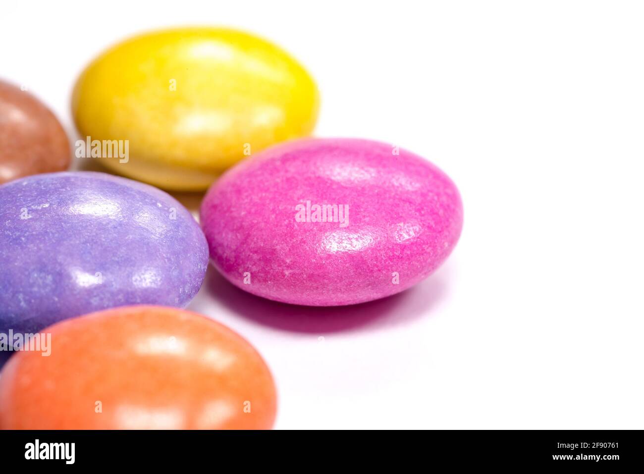 Colorful dragees, close-up on a white background. Chocolate candies in ...