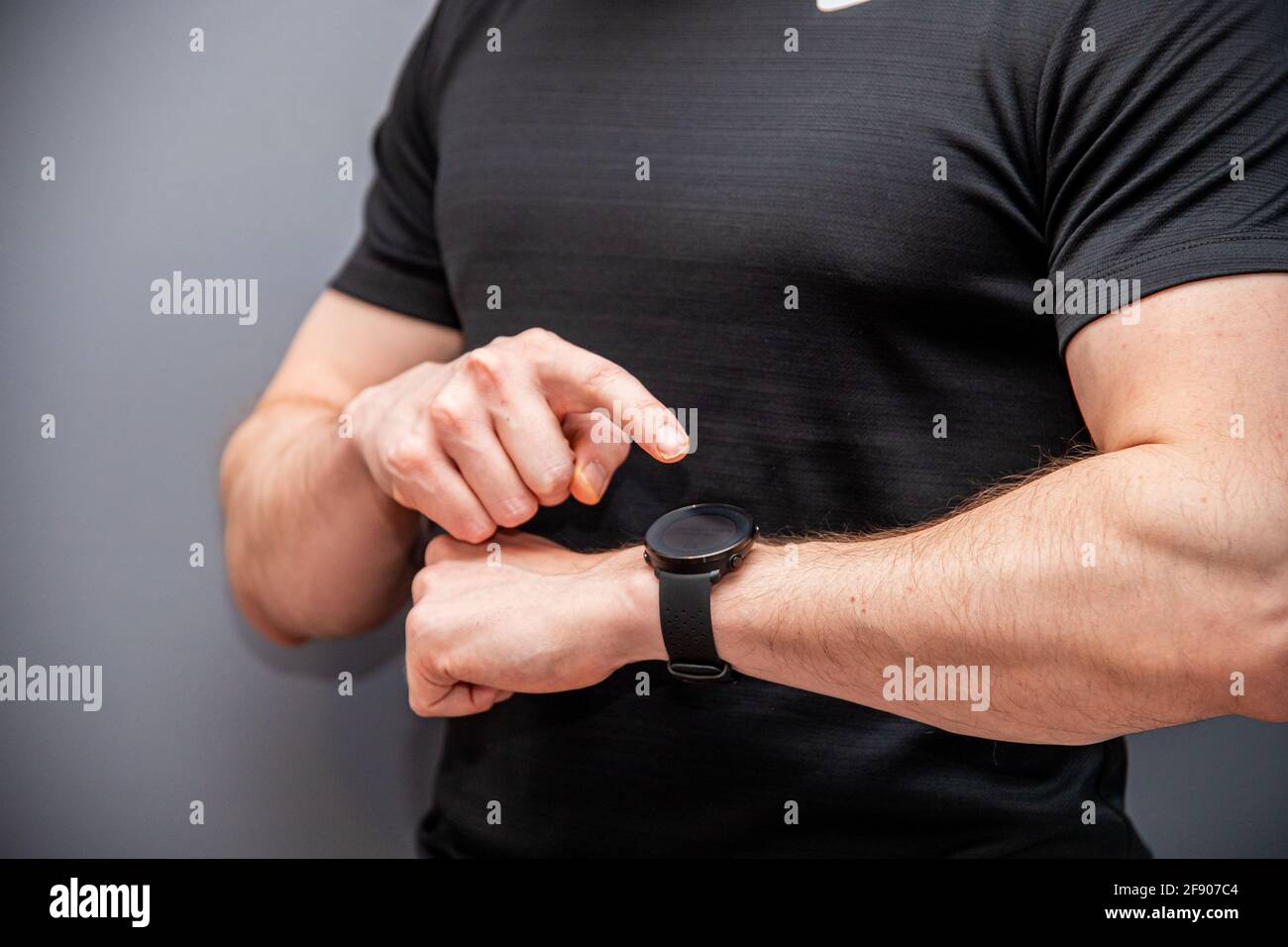Closeup shot of a man pointing at his watch Stock Photo - Alamy