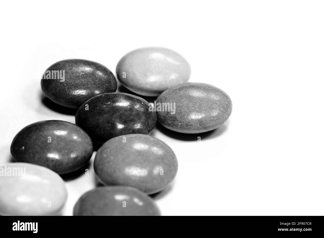 Colorful dragees, close-up on a white background. Chocolate candies in ...