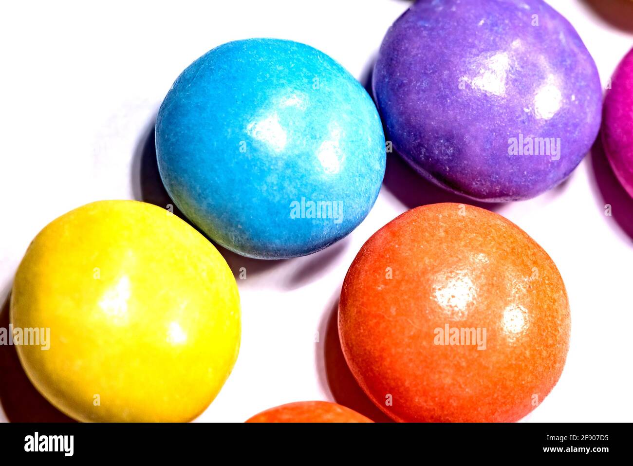 Colorful dragees, close-up on a white background. Chocolate candies in ...