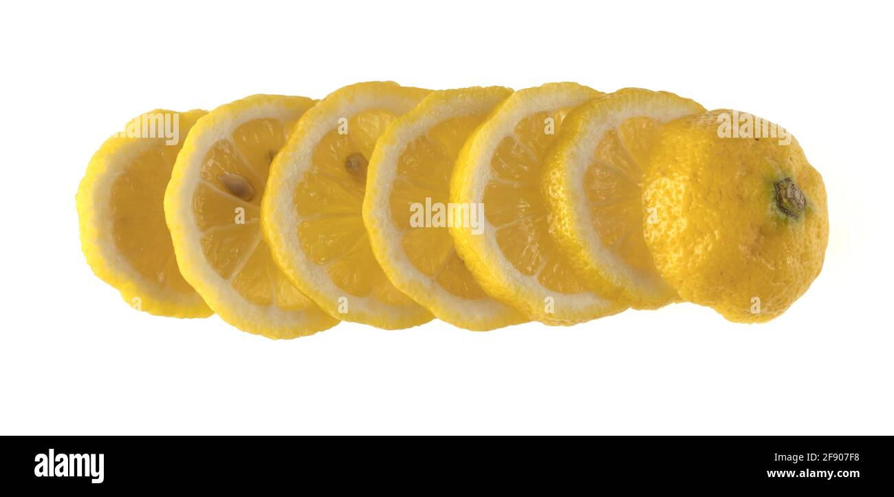 Lemon sliced in wedges and laid out in a row on a white background ...