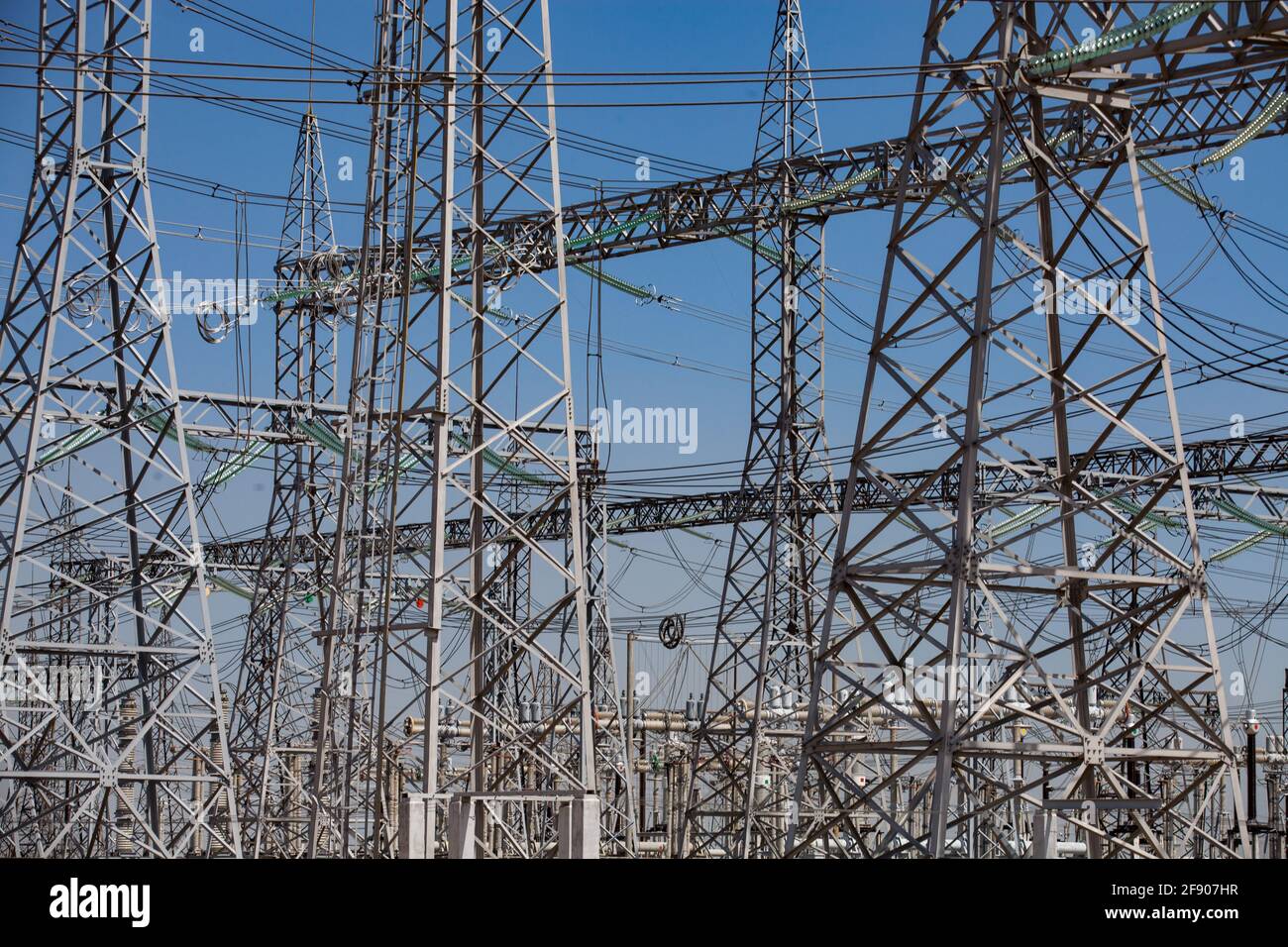Electricity distribution substation. Pylons and cables. Blue sky ...