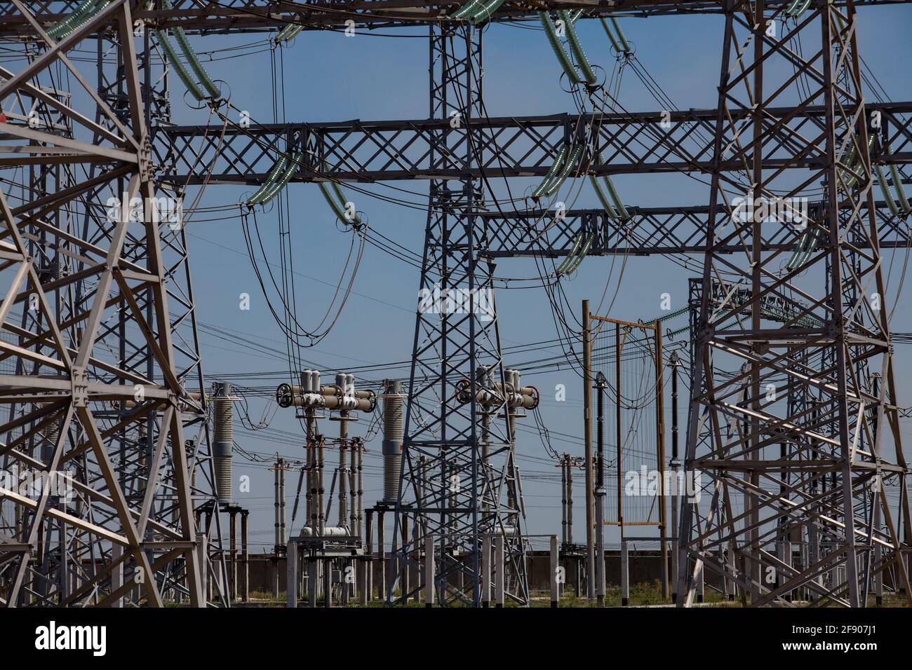 Electric pylons and wires. Distributing substation close-up. Blue sky ...