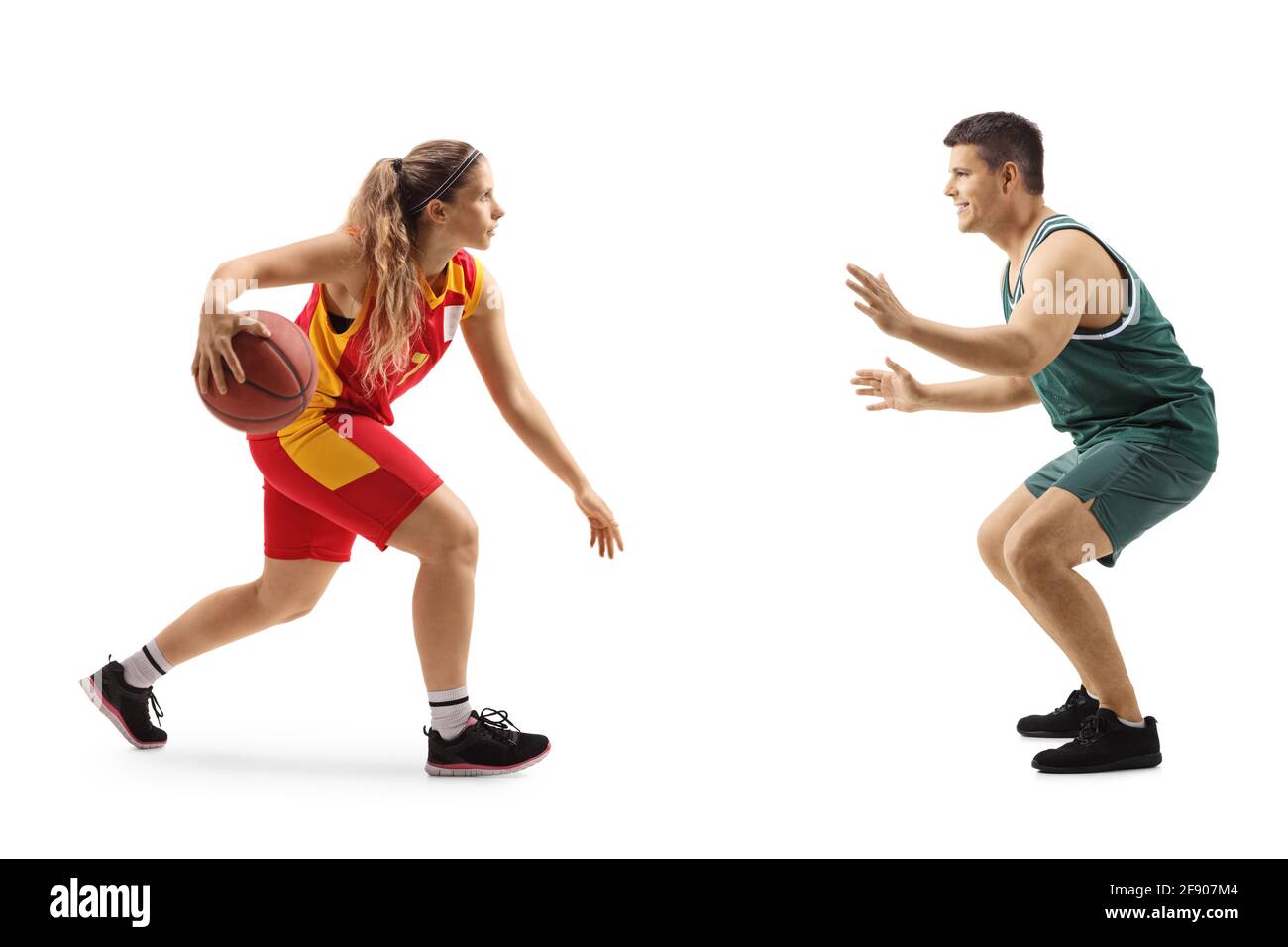Full length profile shot of a female basketball player and a male ...