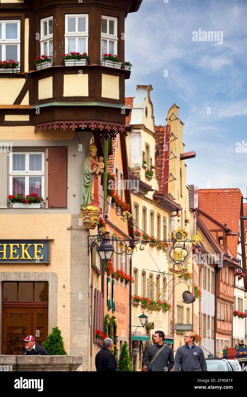 Colorful street lined with traditional timber-frame houses and shops in ...