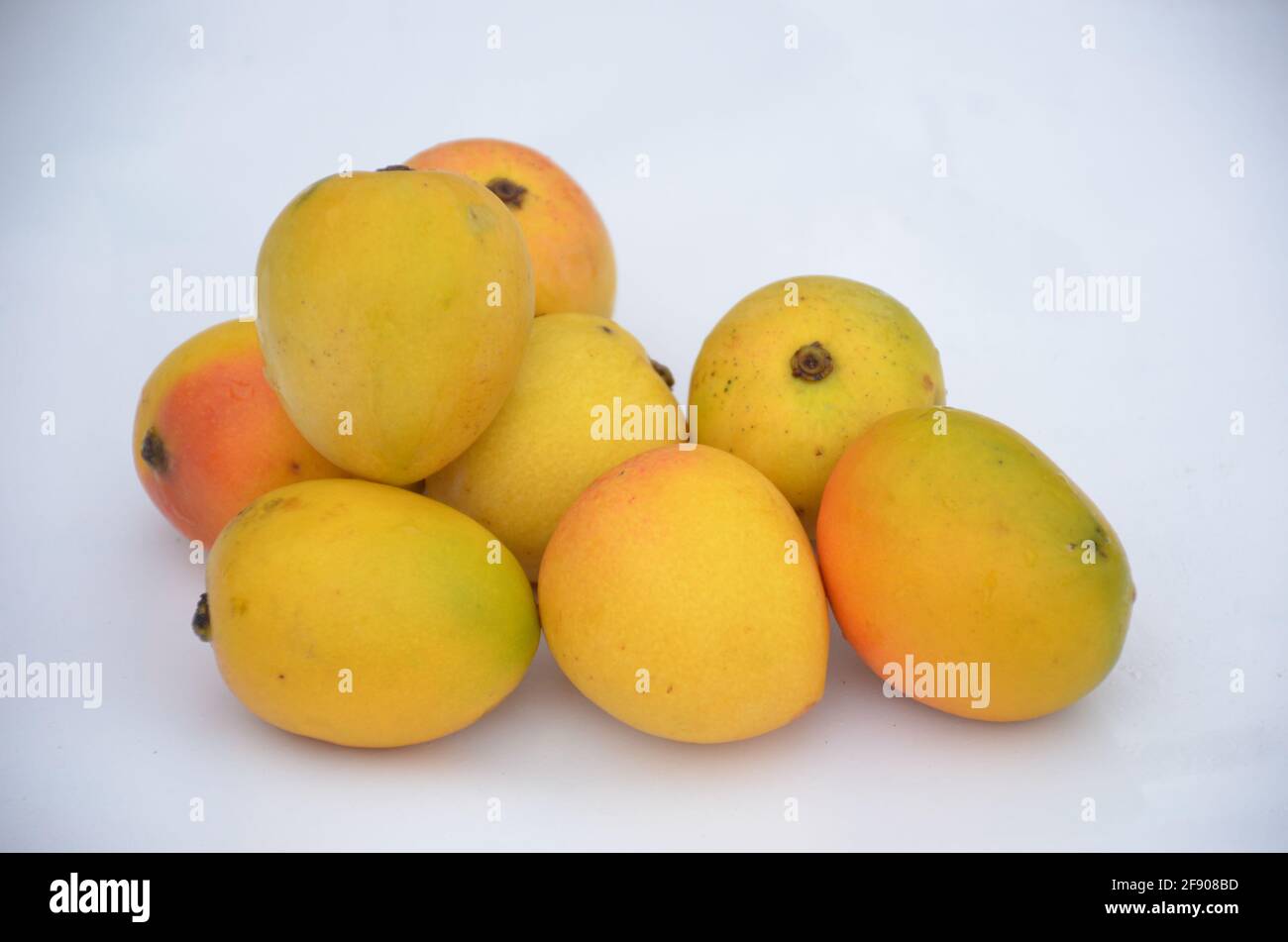 Bunch of red yellow mangos isolated on a white background Stock Photo ...