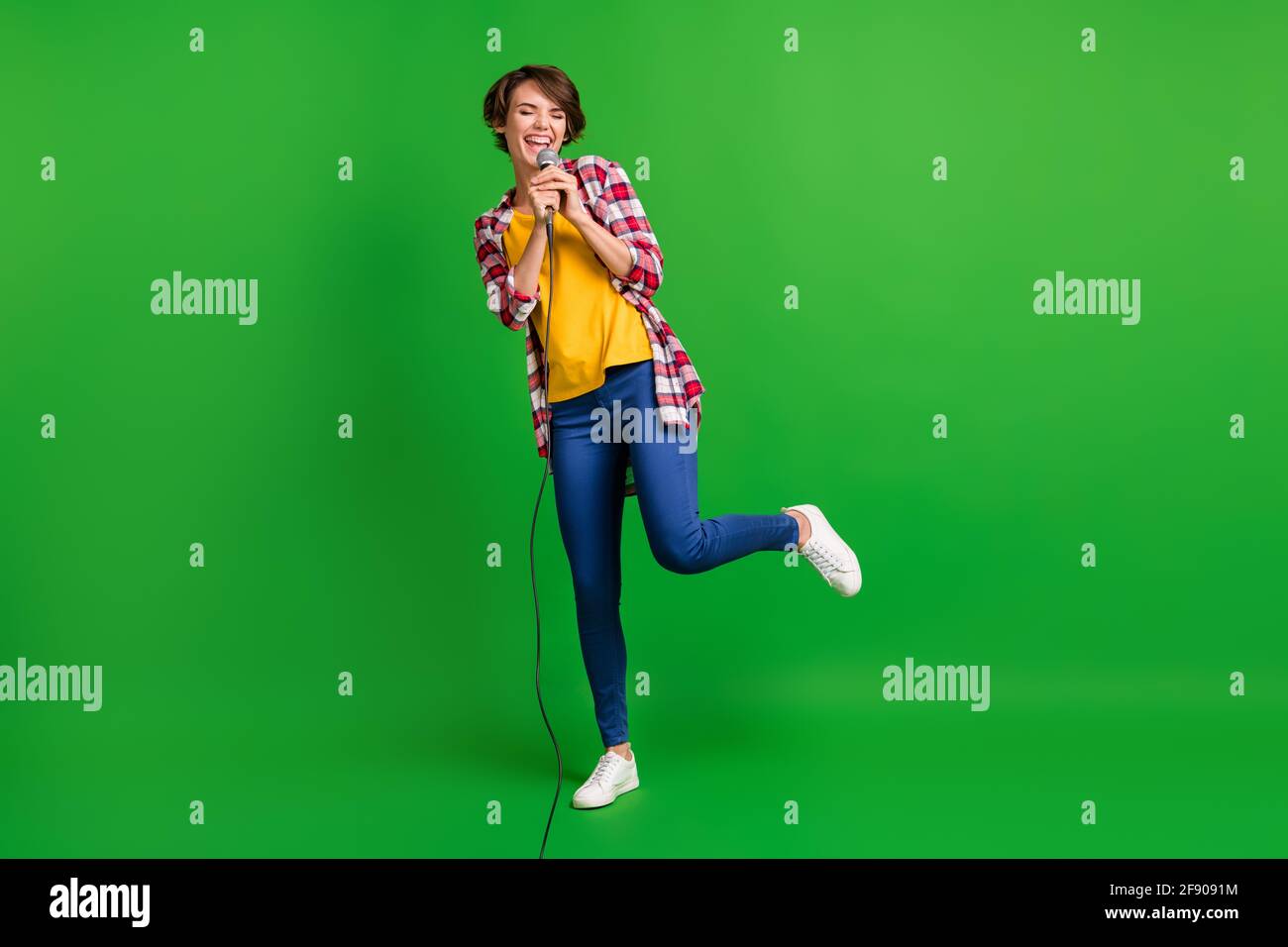 Full size photo of pretty funky girl singing in microphone wear jeans ...