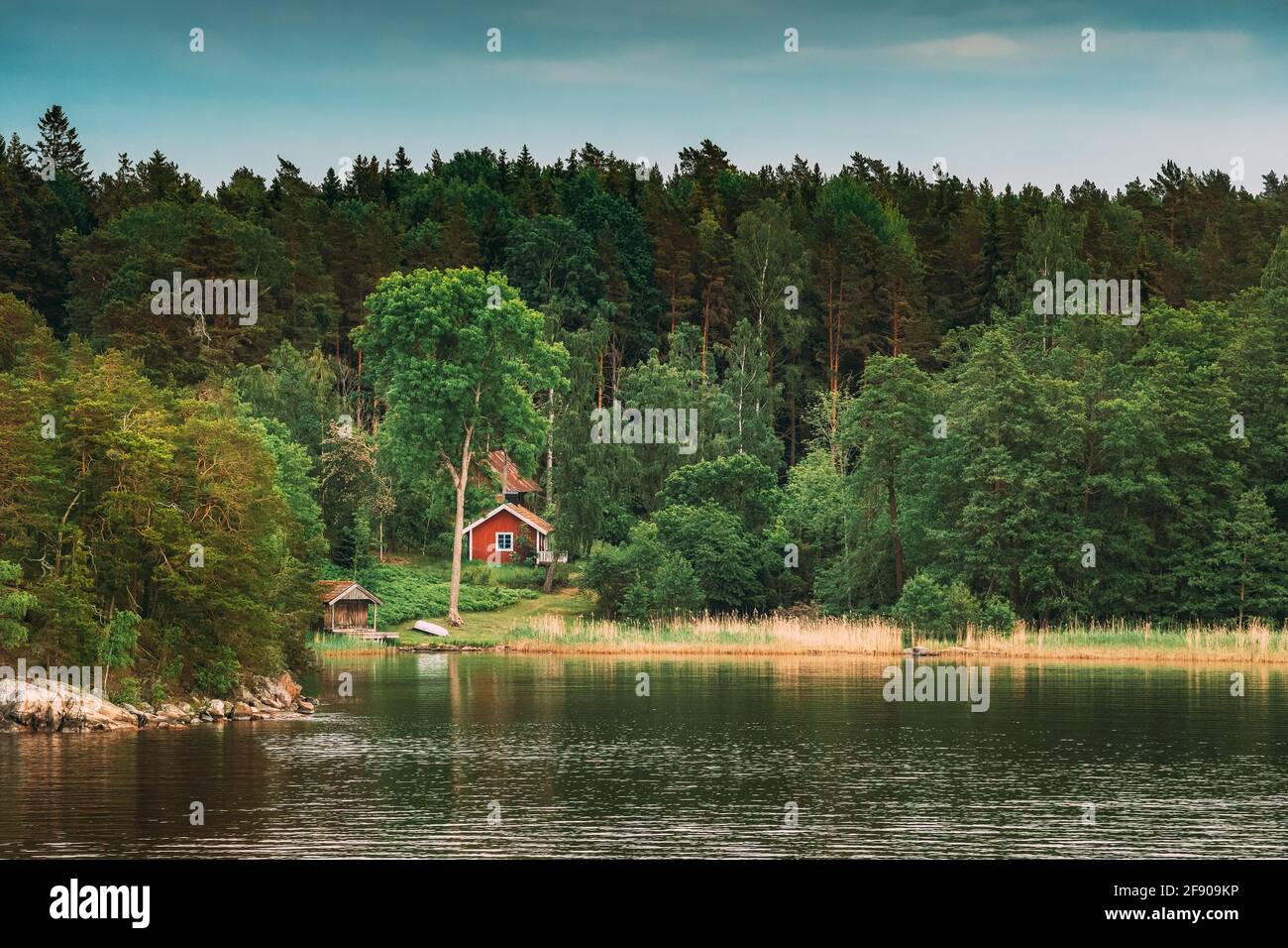 Sweden. Beautiful Red Swedish Wooden Log Cabin House On Rocky Island ...