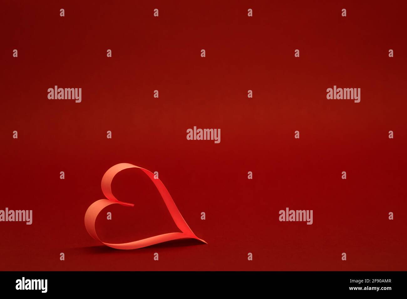Heart of paper on a red background Stock Photo - Alamy