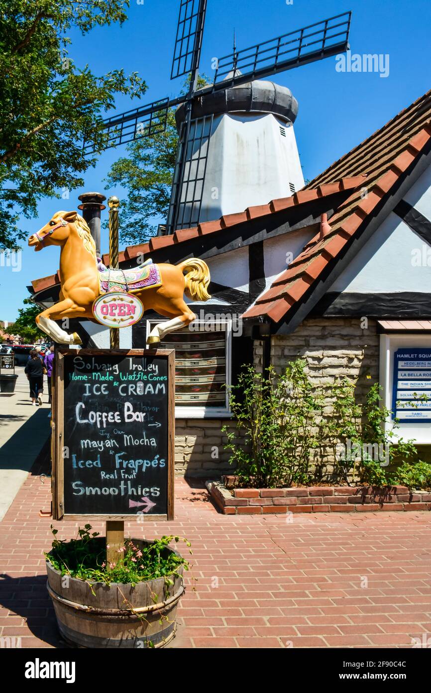 An iconic windmill overlooks Hamlet Square with shops and carousel ...