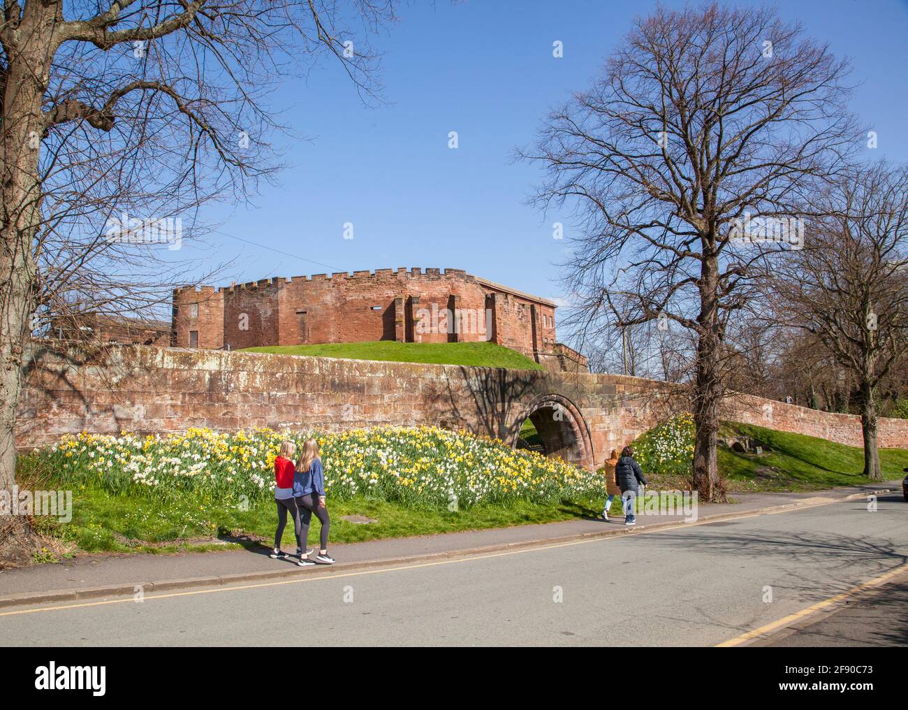 People walking past The Chester Castle and Agricola Tower, standing ...
