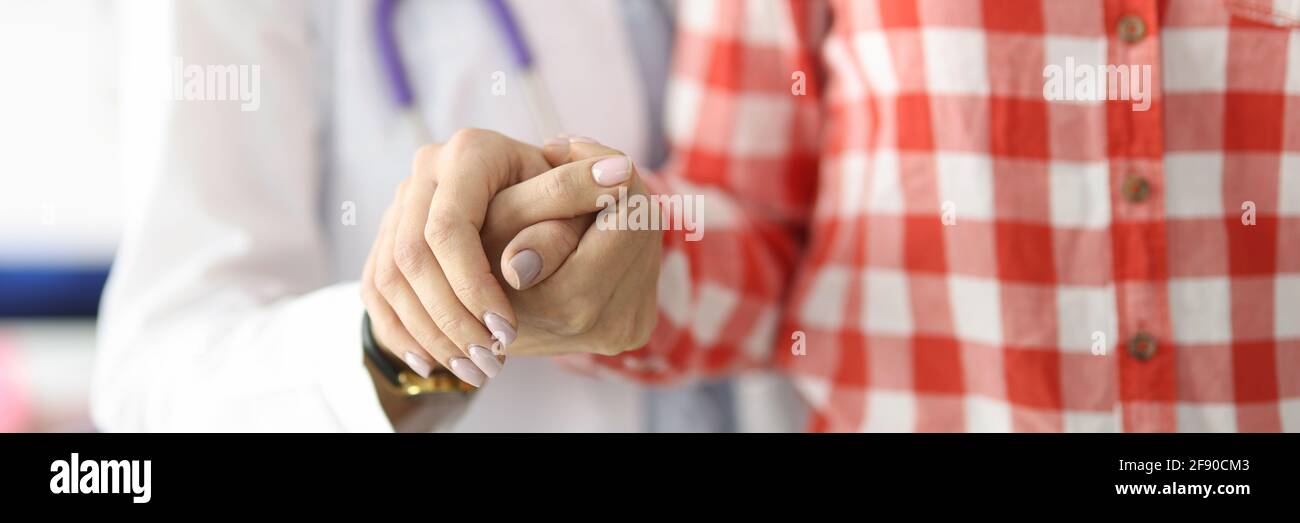 Doctor supporting patient by hand and helping to go to clinic Stock ...
