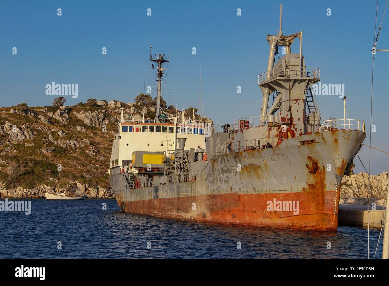 On the pier stands an iron old marine ship covered in rust Stock Photo ...