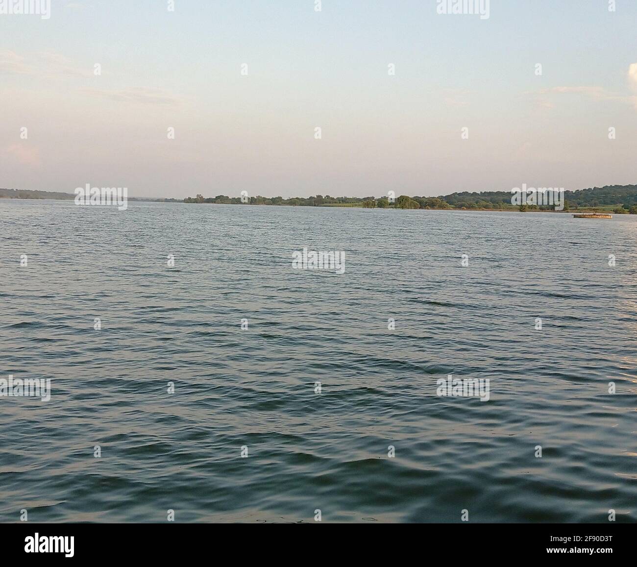 Beautiful view of a calm lake with trees in the background Stock Photo ...