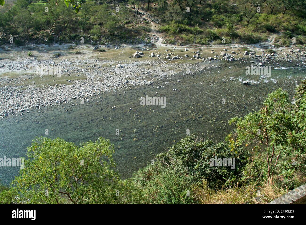 Natural view of a shallow river flowing downstream in the countryside ...
