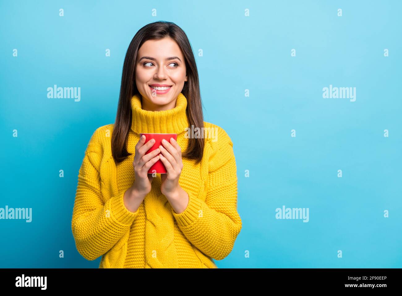 Portrait of pretty cheerful girl drinking cacao looking aside copy ...