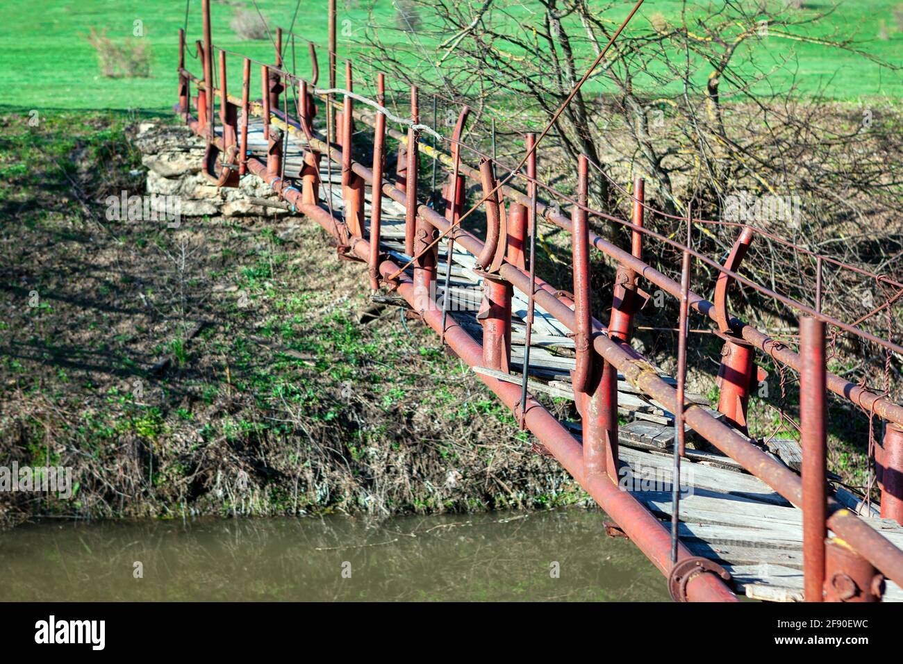 Suspension old footbridge over the river . Old Bridge constructed with ...
