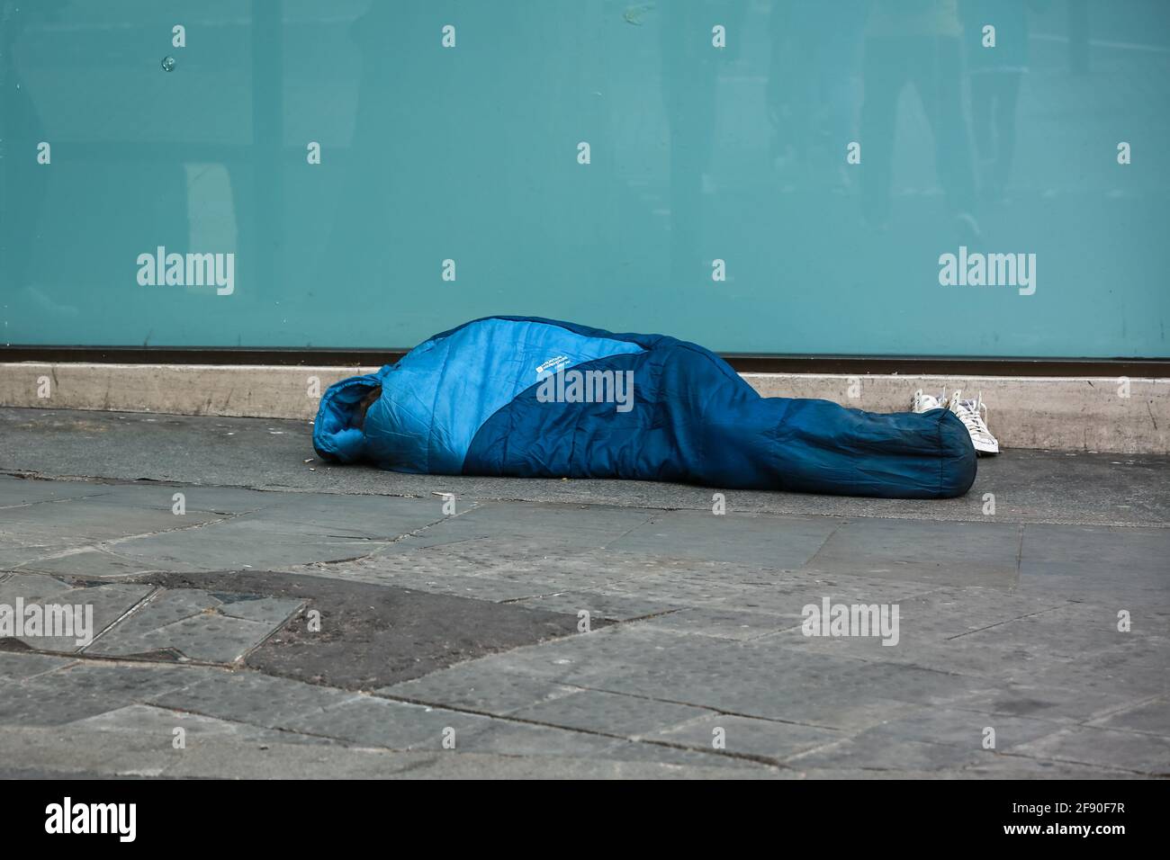 London, UK. 13 April 2021. A homeless man sleeps in a sleeping bag in ...