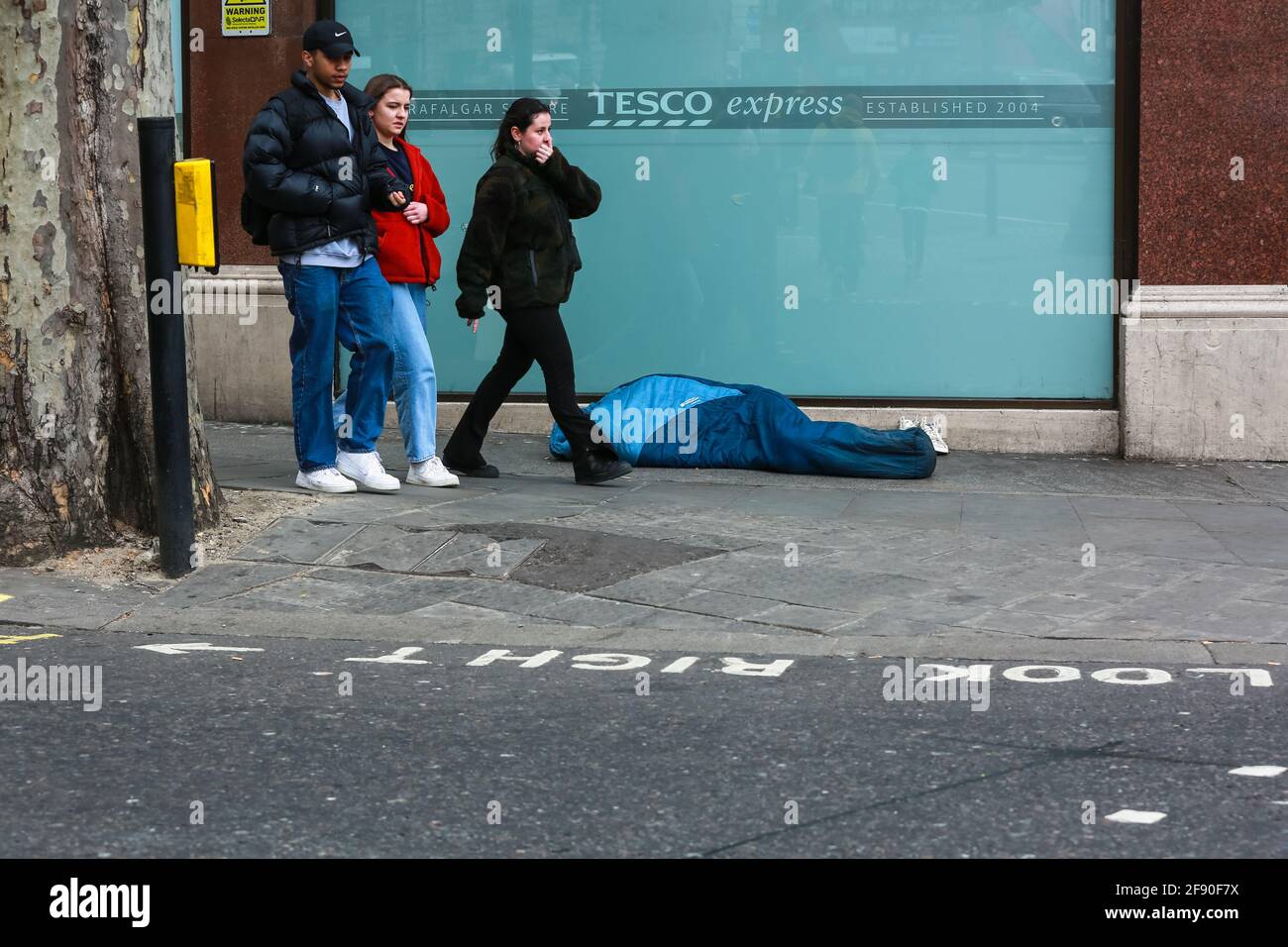 London, UK. 13 April 2021. A homeless man sleeps in a sleeping bag in ...