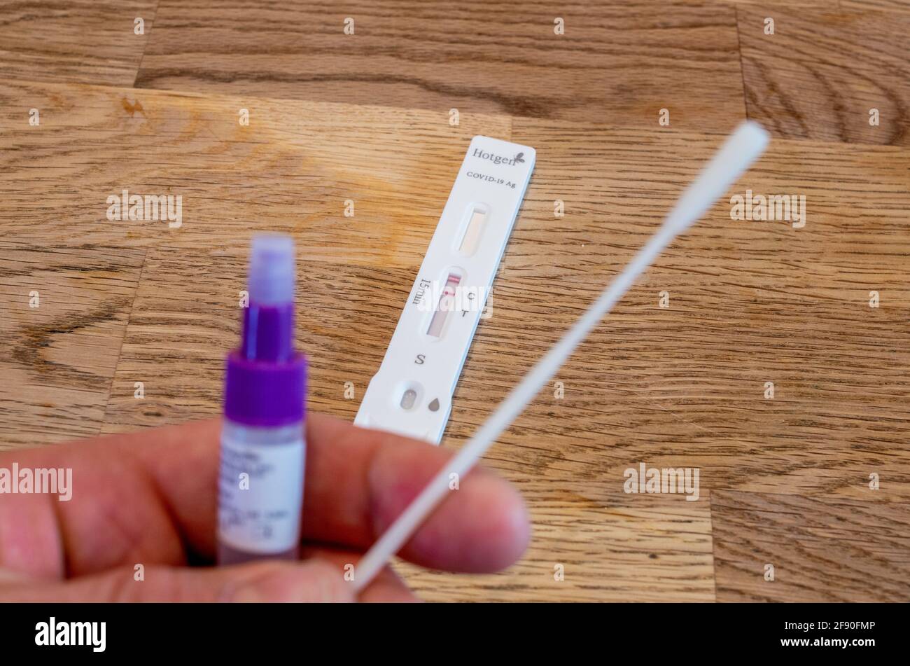 Bamberg, Germany - 8.4.2021. Hand with Corona self-test kit from Hotgen ...