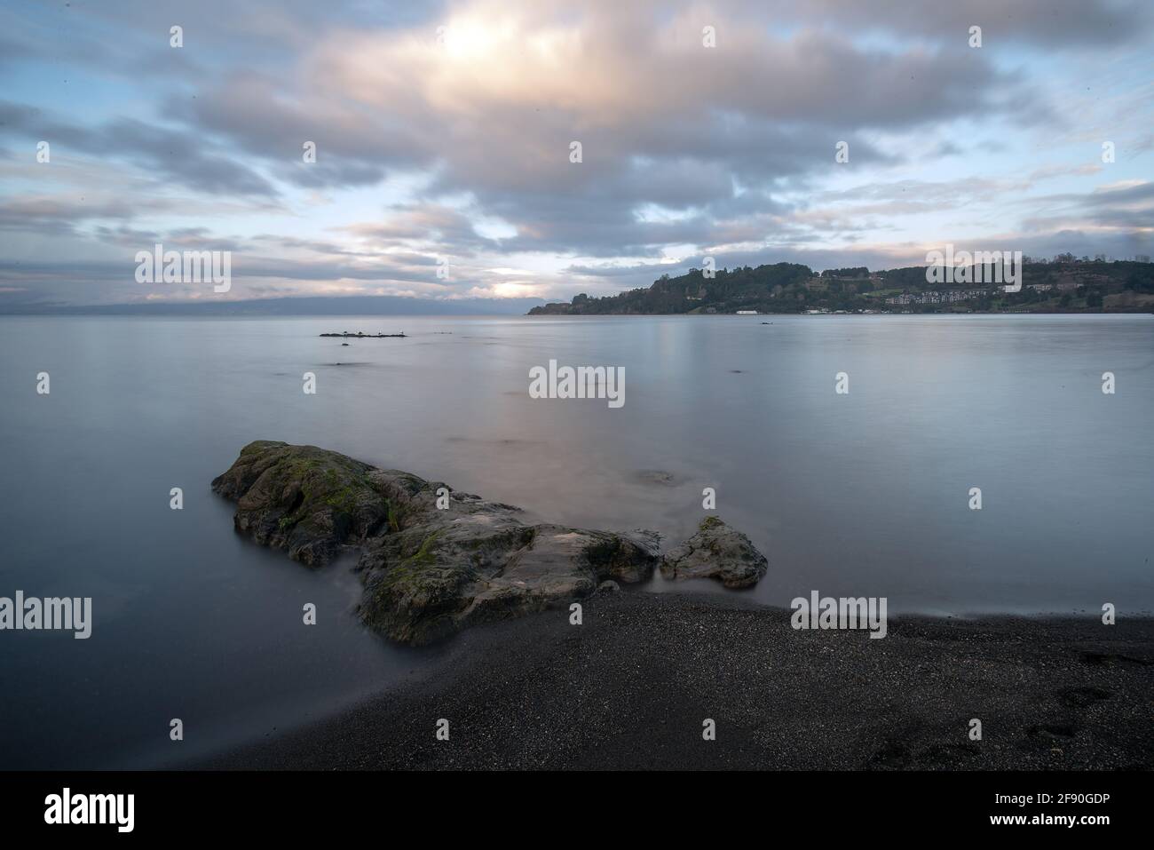Scenic view of a calm coast under a cloudy morning sky background Stock ...