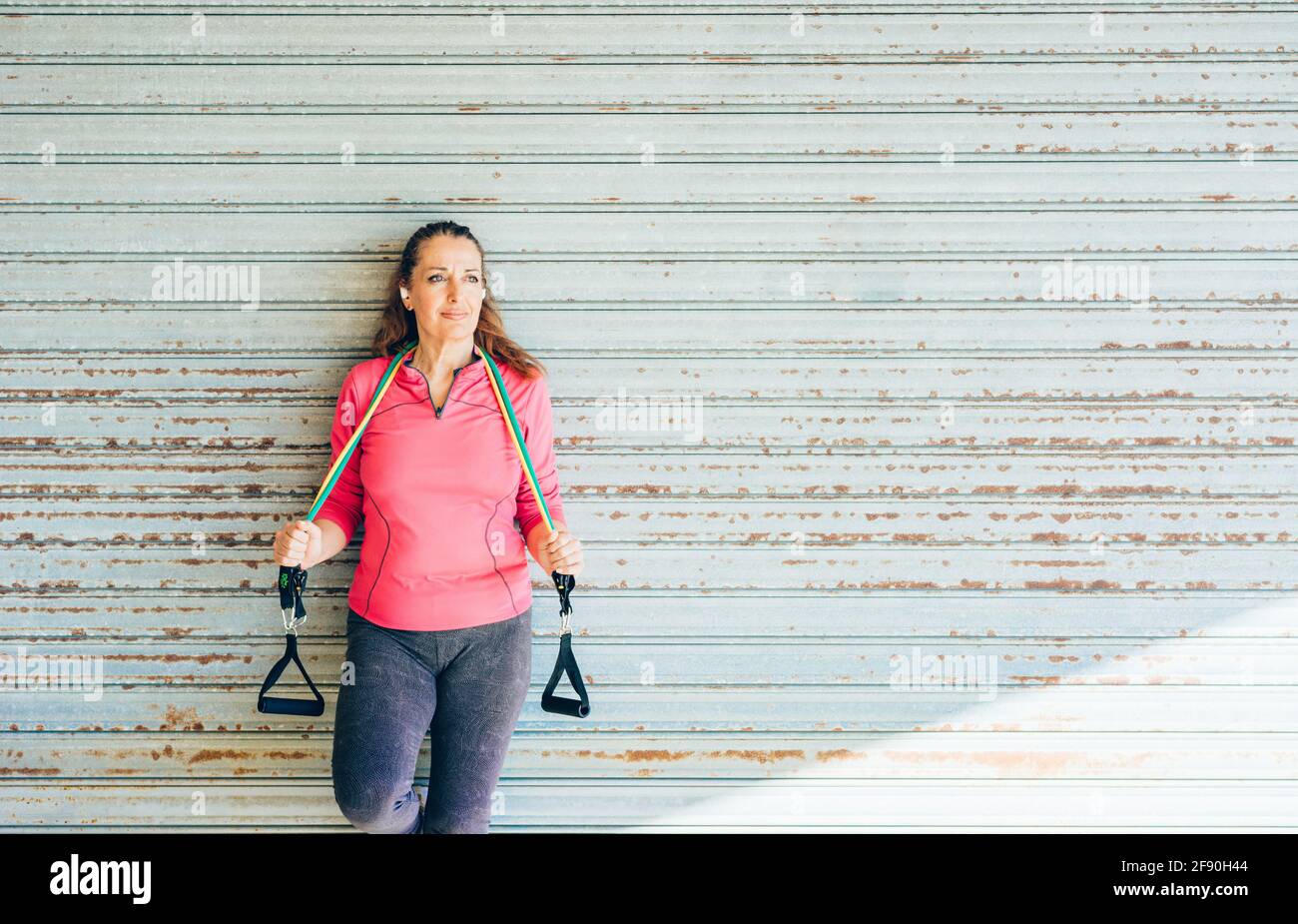 Woman doing a workout with elastic bands in a gym Stock Photo - Alamy