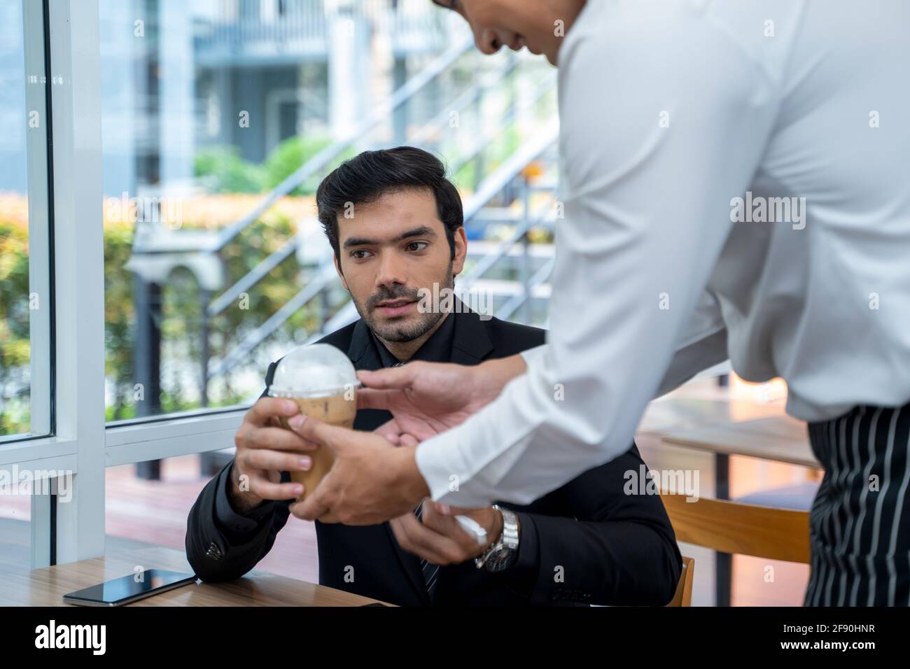 Barista serving coffee hi-res stock photography and images - Alamy