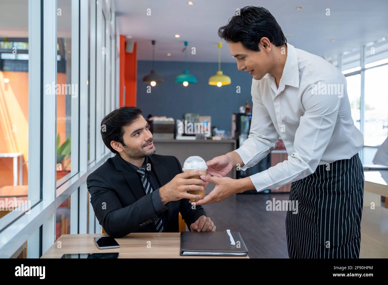 Barista serving coffee hi-res stock photography and images - Alamy