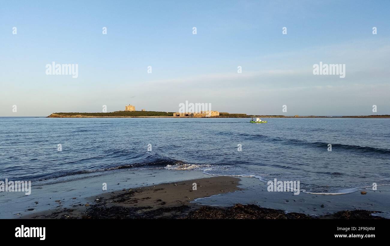 Beautiful view of Capo Passero Island under a blue sky from Portopalo ...