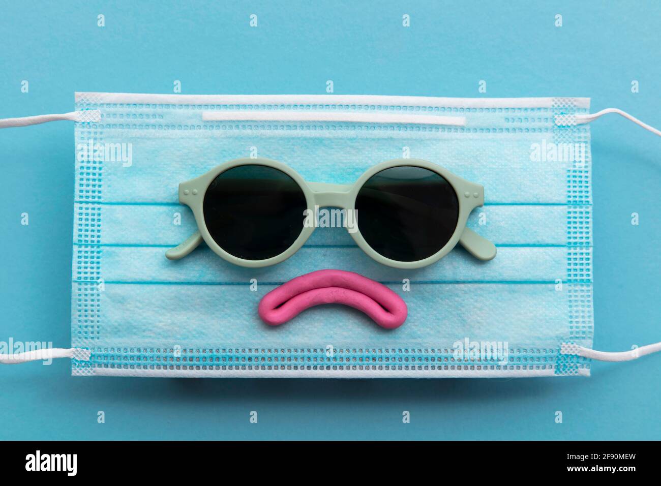 Unhappy sad face character made from a medical protective face mask ...