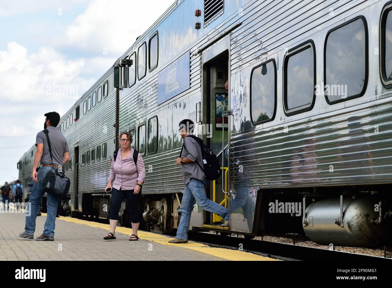 Bartlett, Illinois, USA. Passengers exit an outbound Metra commuter ...