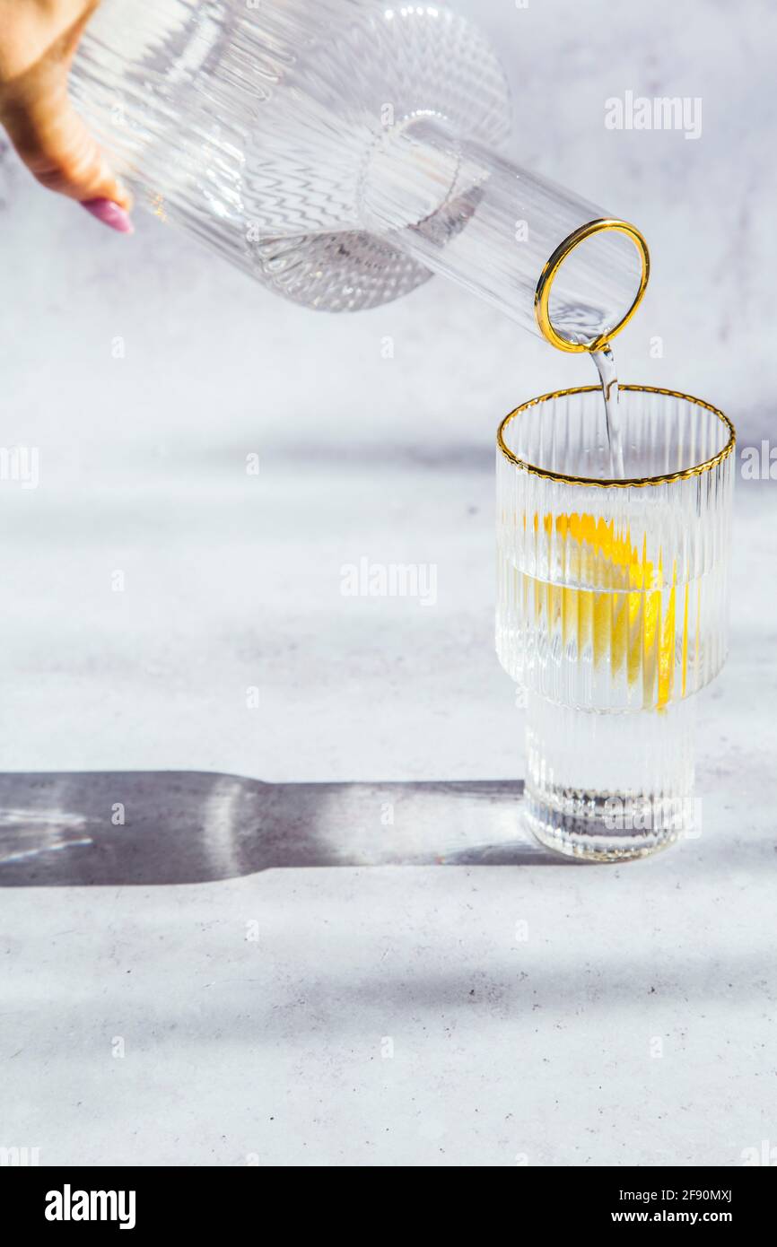 Glass of water and hard shadows Stock Photo - Alamy