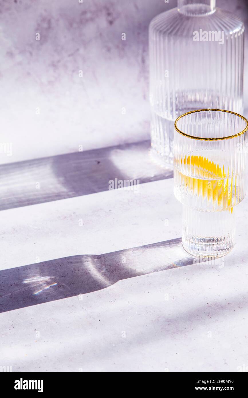 Glass of water and hard shadows Stock Photo - Alamy