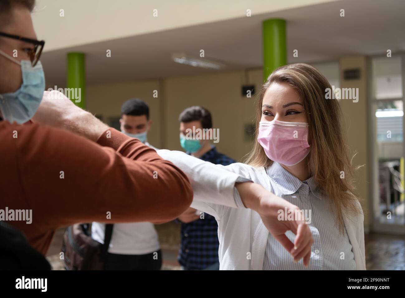 students greeting new normal coronavirus handshake and elbow bumping ...