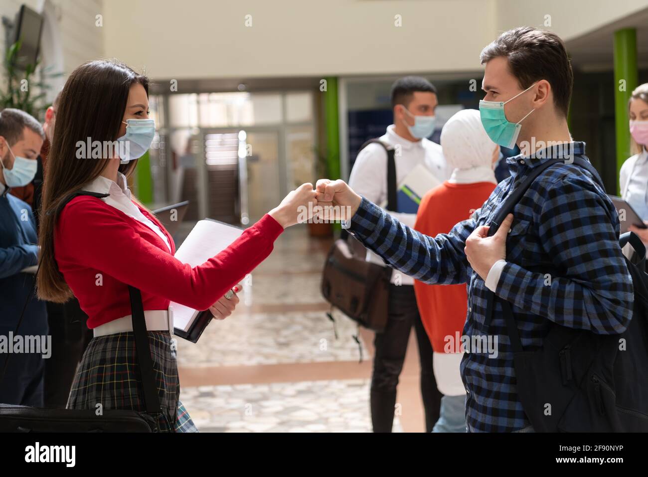 students greeting new normal coronavirus handshake and elbow bumping ...
