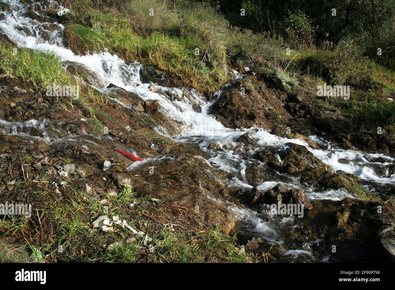 Natural view of a small waterfall flowing downstream from a hill Stock ...