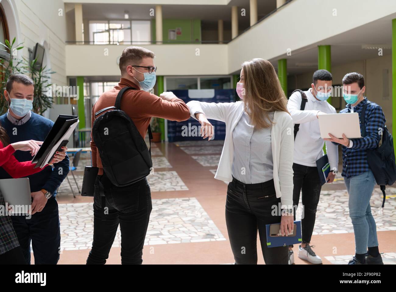 students greeting new normal coronavirus handshake and elbow bumping ...
