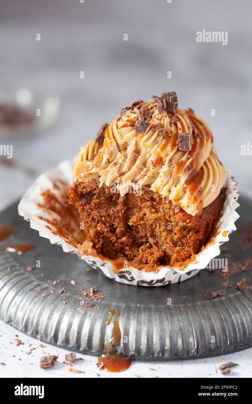 A part eaten mocha cake in its paper wrapper Stock Photo - Alamy