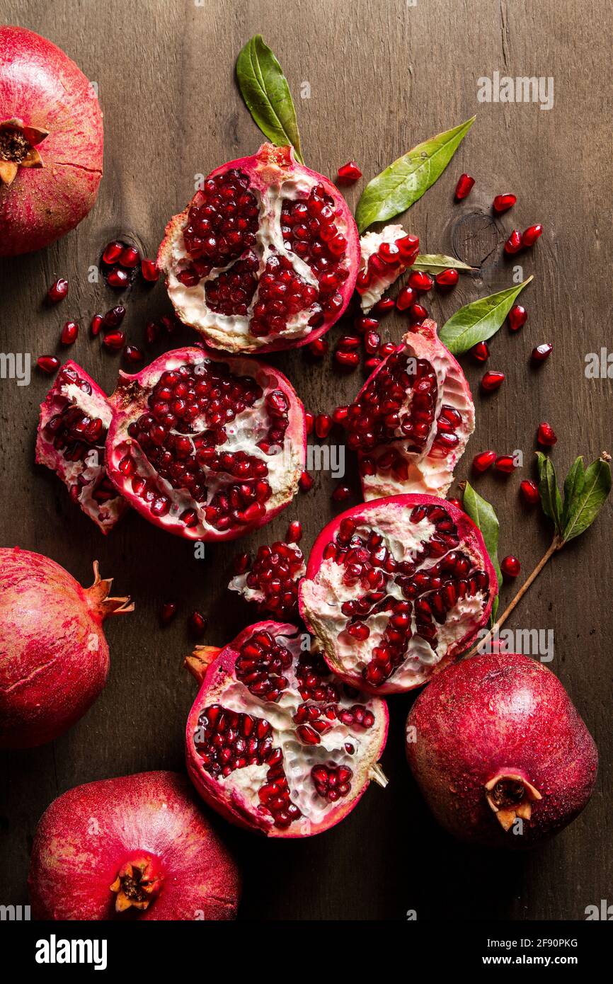 Pomegranates on wood background Stock Photo - Alamy
