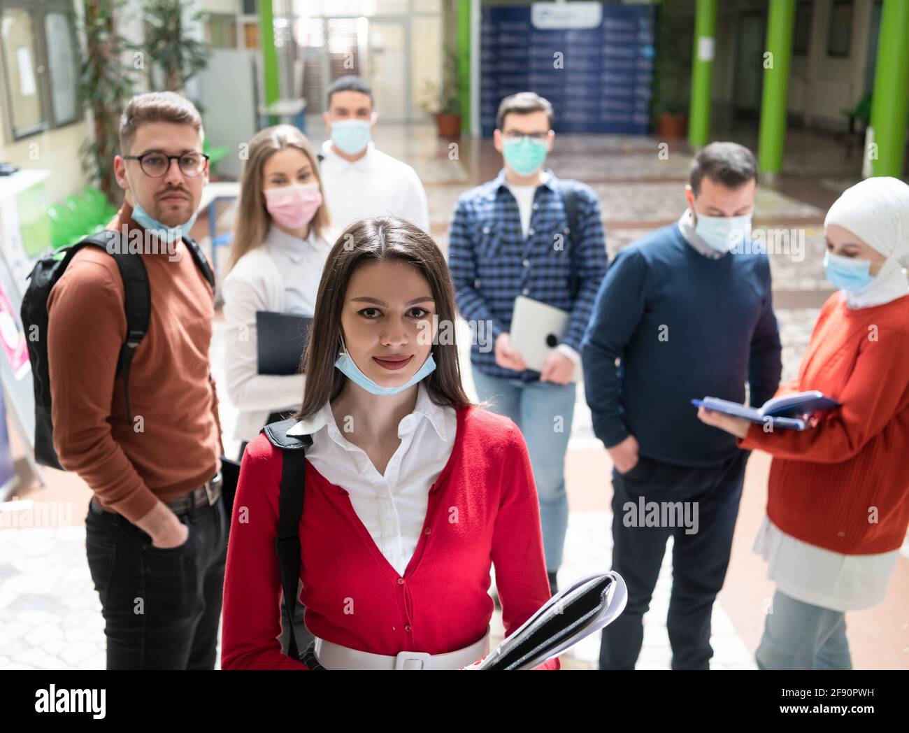 Portrait of multiethnic students group at university wearing protective ...