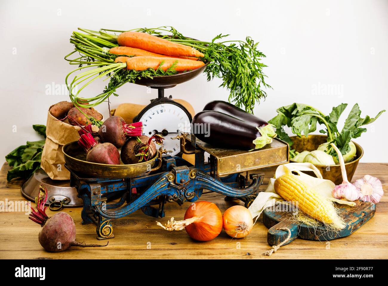 Fresh raw ripe vegetables Healthy food on scales on wooden table ...