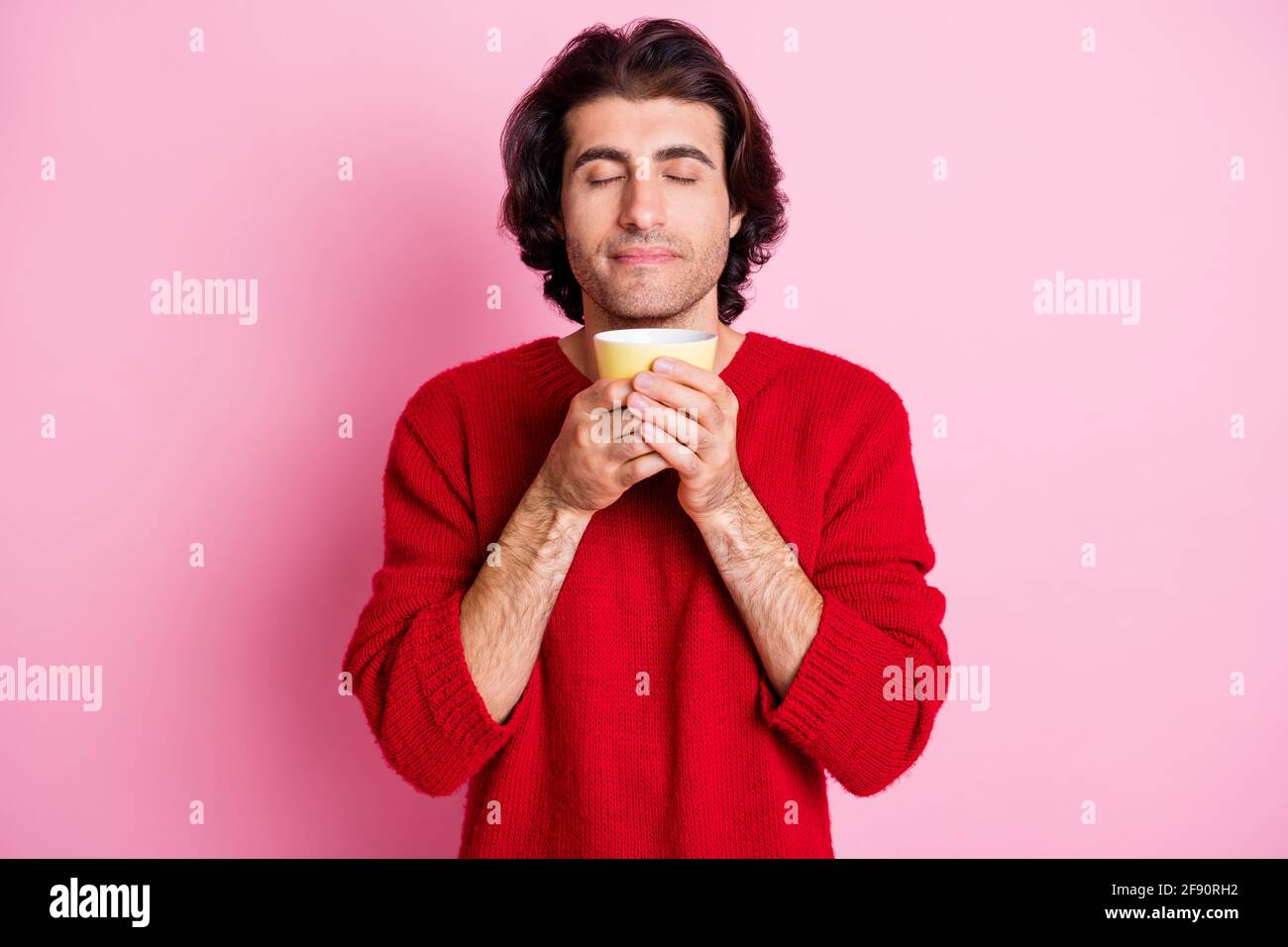 Portrait of nice dreamy peaceful guy drinking caffeine smelling ...