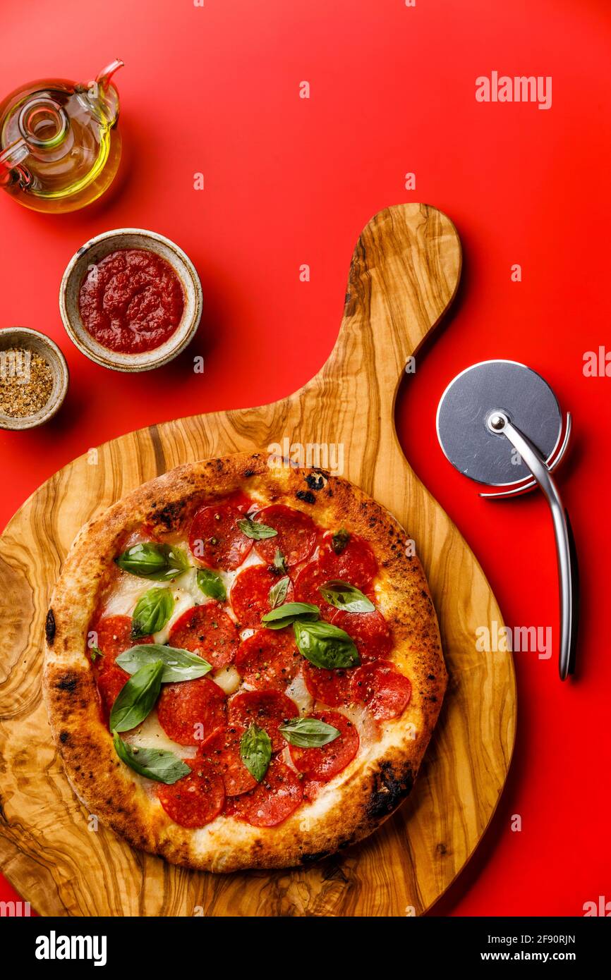 Pepperoni Pizza on red background Stock Photo - Alamy