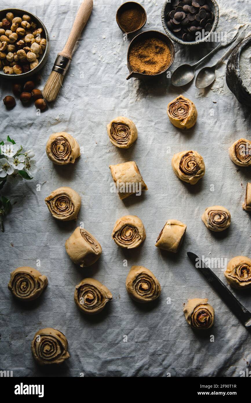 The process of making of chocolate rolls on the table cloth with ...