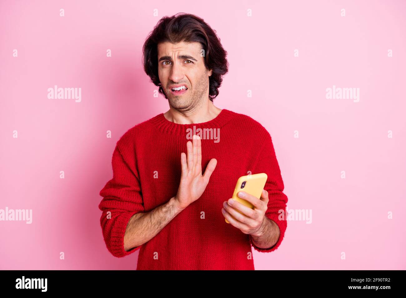 Portrait of nice disappointed guy using device browsing fake news ...